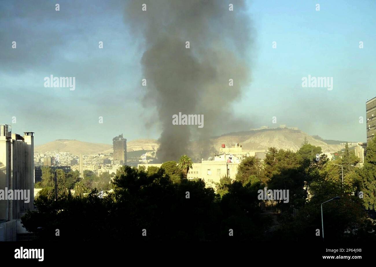 Smoke rises after two cars bombs detonated at Syria army headquarters ...