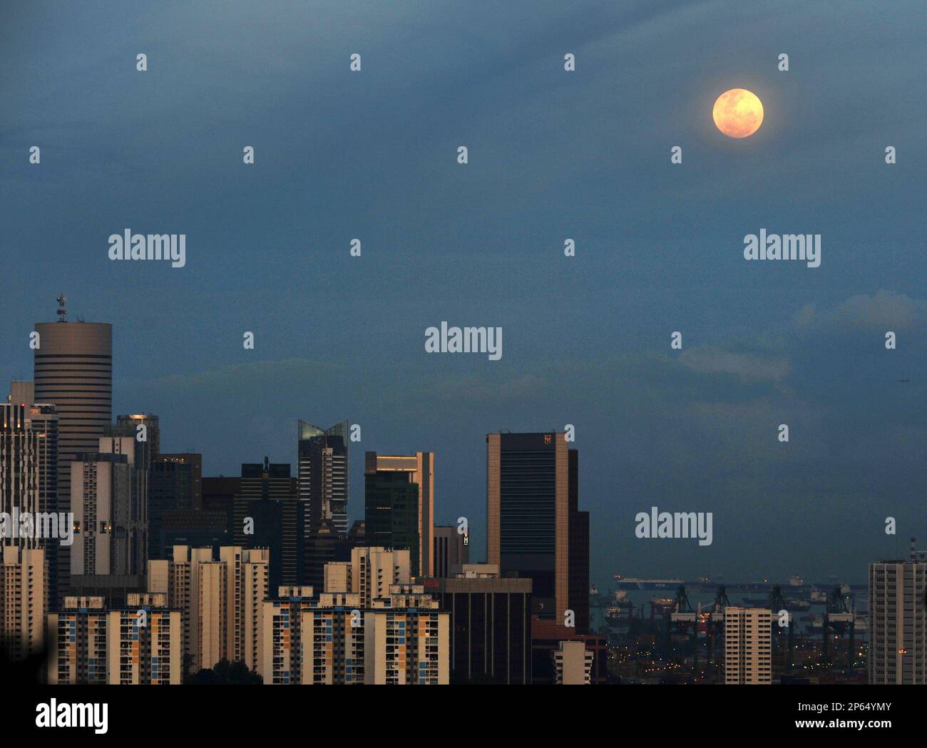 Photograph of the full moon as it rises over Singapore on 19 March 2011 ...