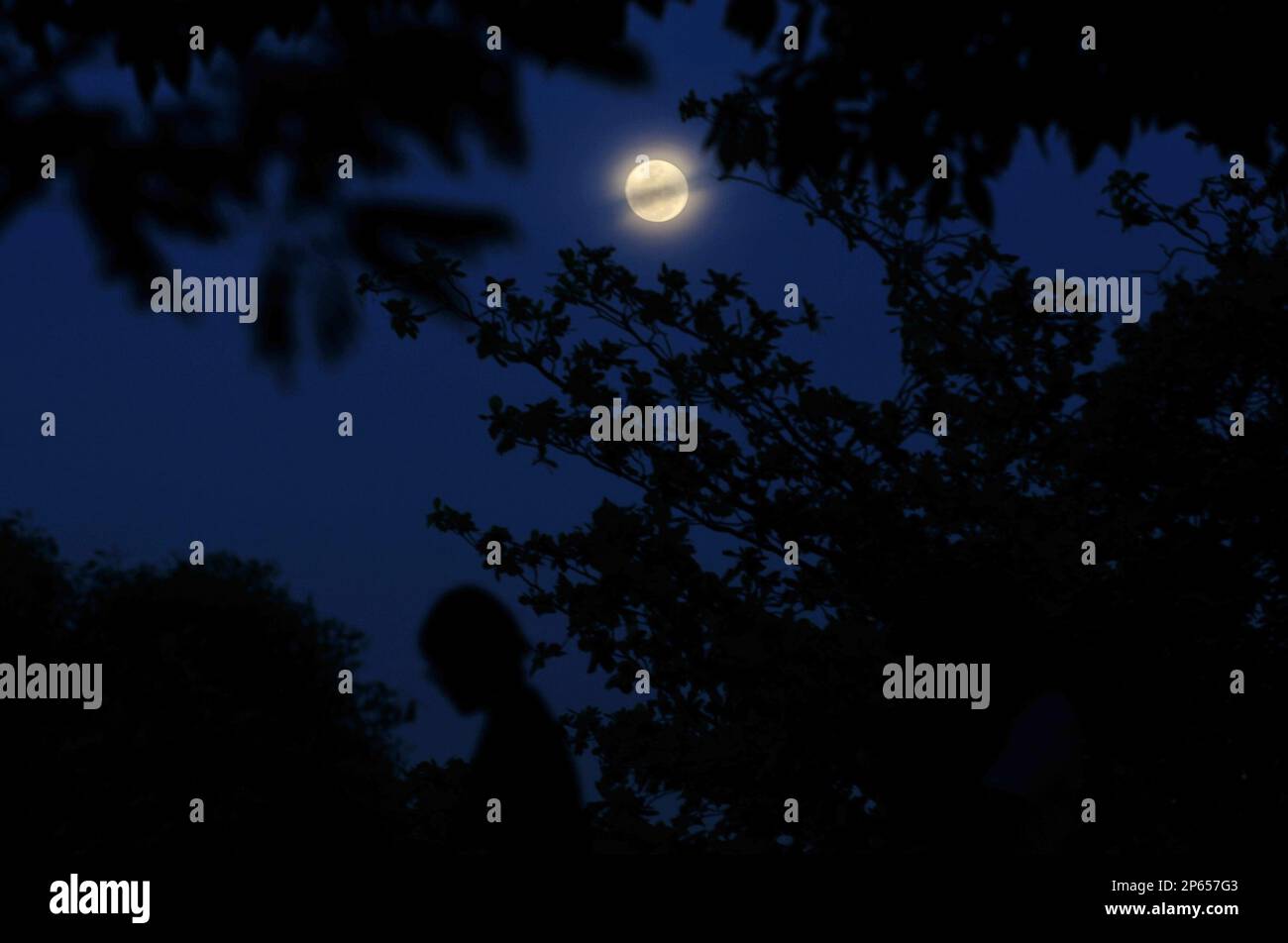 Photograph of the full moon as it rises over Singapore on 19 March 2011 ...