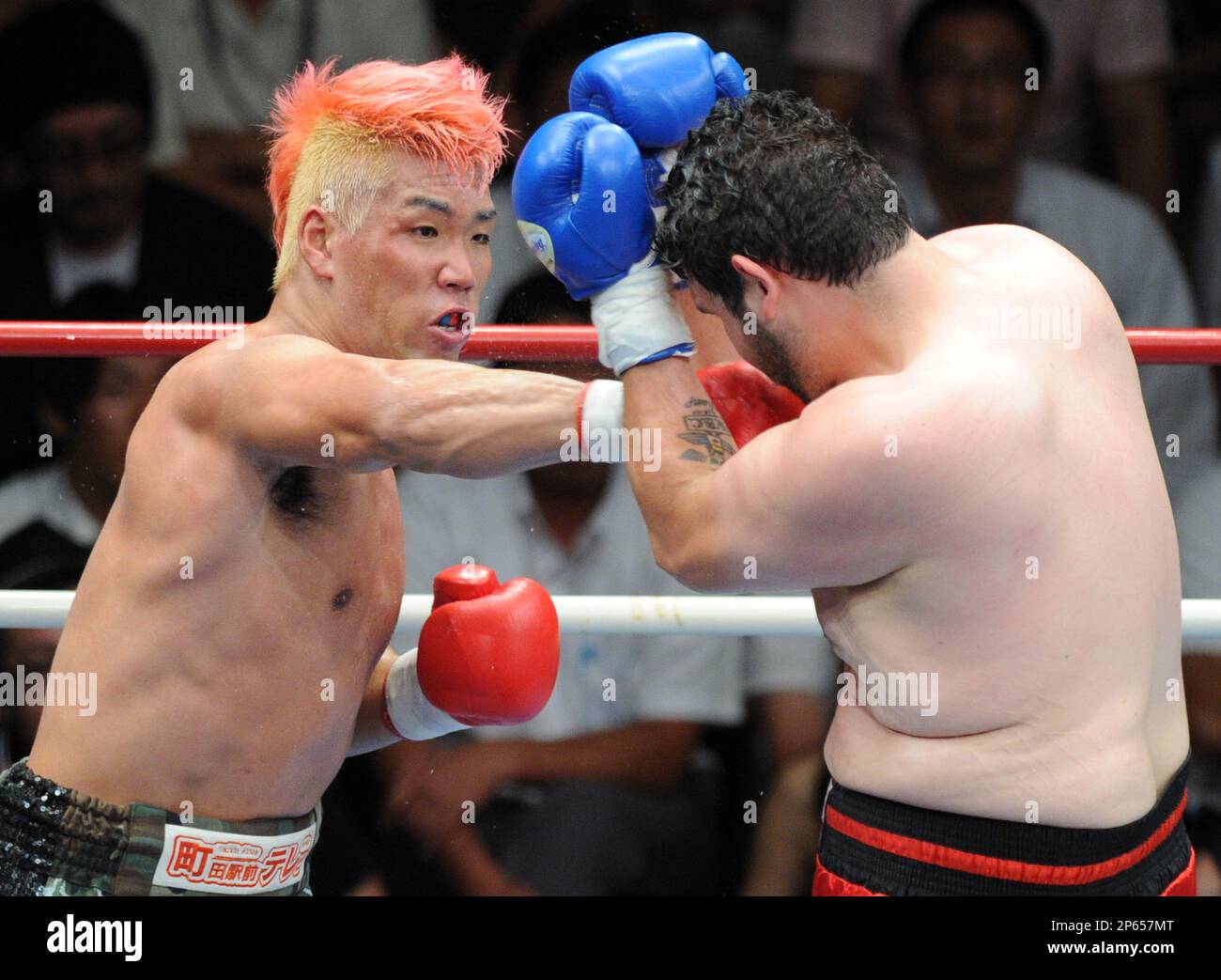Japan's Kyotaro Fujimoto (L) hits Chauncy Welliver of U.S.A during the ...