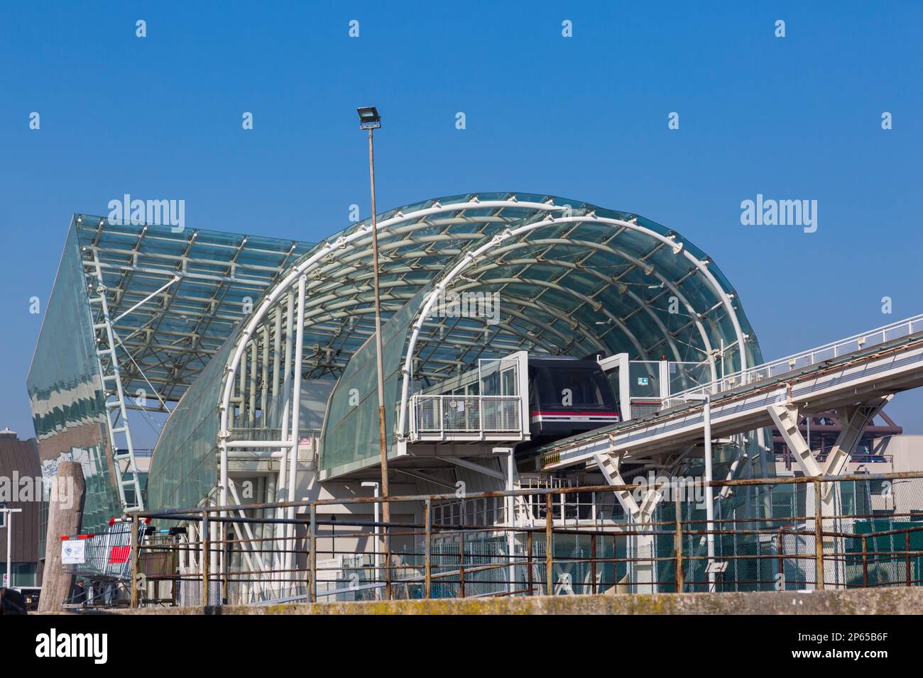 Glass train station, monorail, people mover shuttle service taking ...