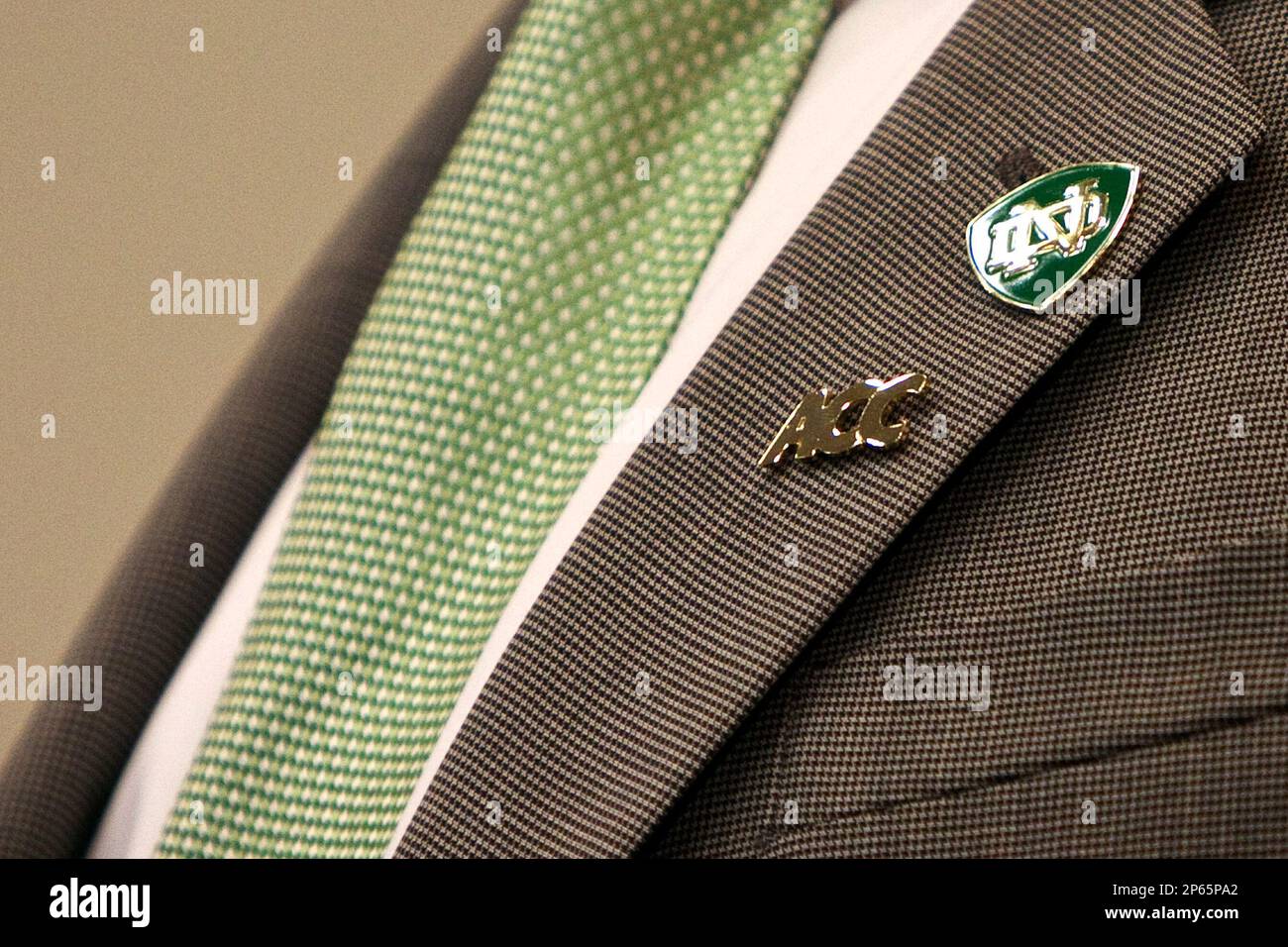 Notre Dame athletic director Jack Swarbrick wears buttons bearing the ...