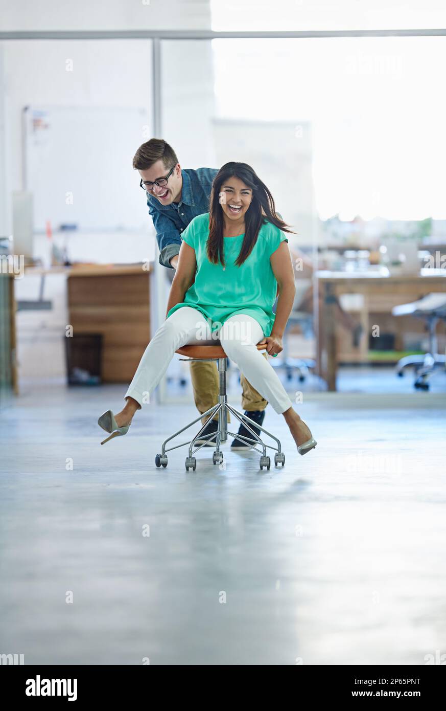 Breaktime is fun time. a male coworker pushing his female coworker ...