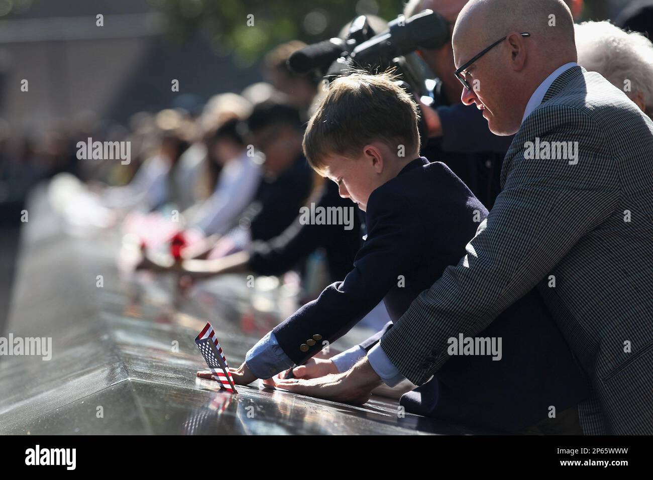 Andrew Timson, 7, etches the name of his slain uncle, Andrew Fisher, at ...