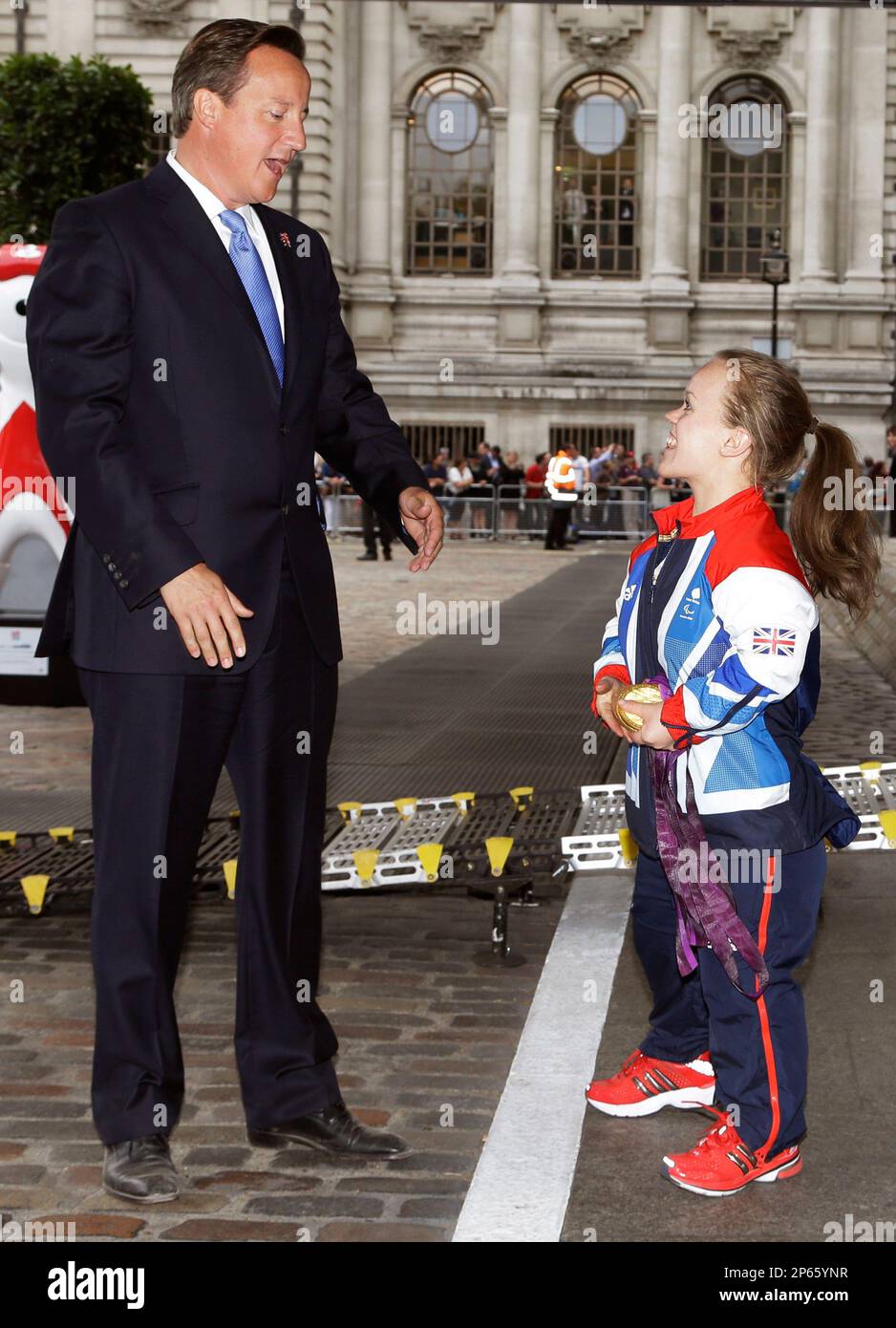 British Prime Minister David Cameron, left, speaks with British swimmer ...