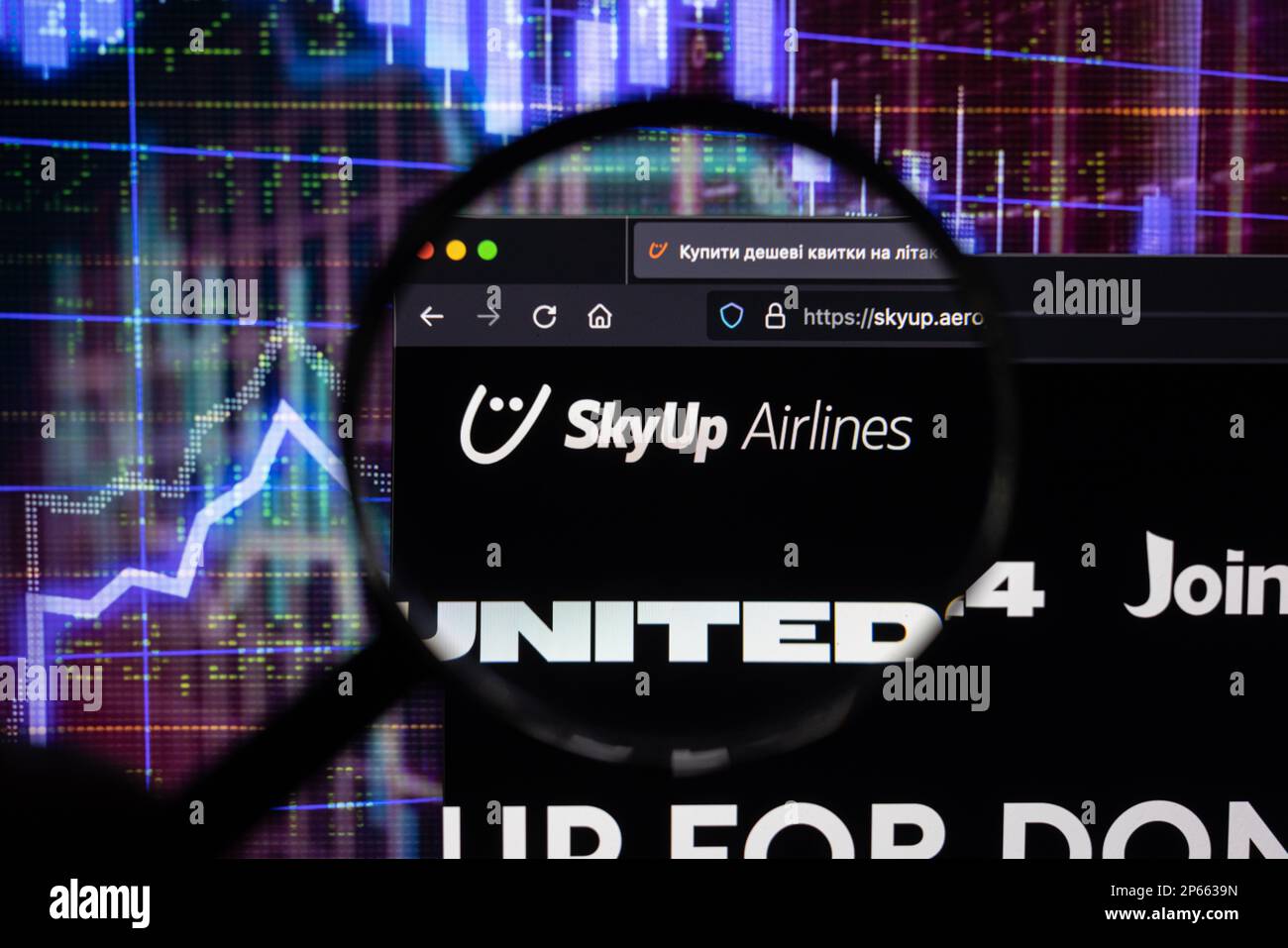 SkyUp airlines company logo on a website with blurry stock market developments in the background ...