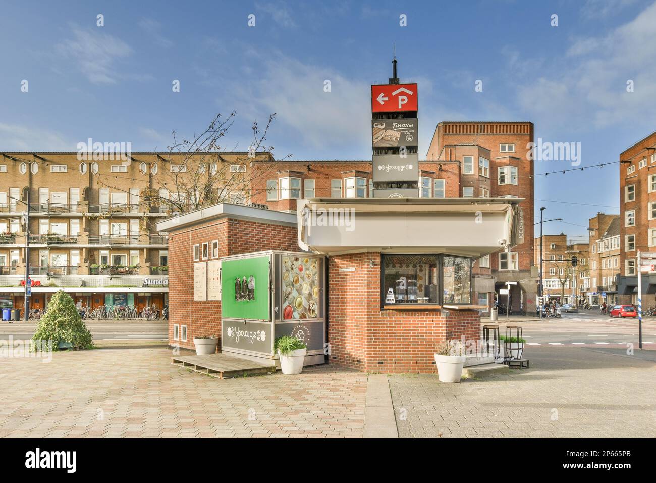 a street corner with buildings in the background and a red stop sign on ...