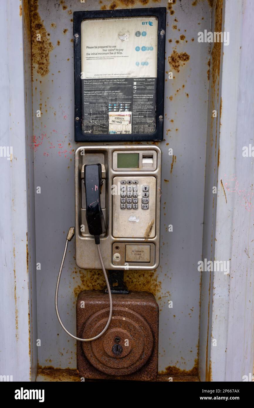 Dirty old coin operated public telephone box rusty and disused Stock ...