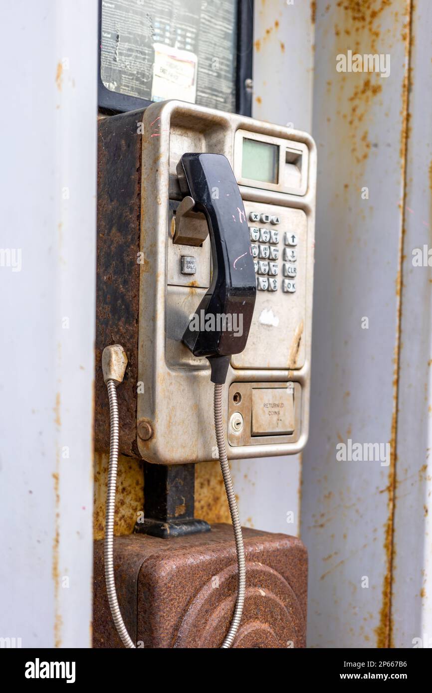 Dirty old coin operated public telephone box rusty and disused Stock ...