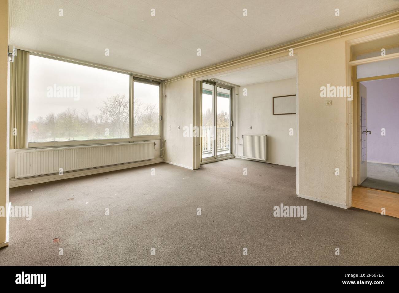 an empty living room with no one person in the room, and there are two ...