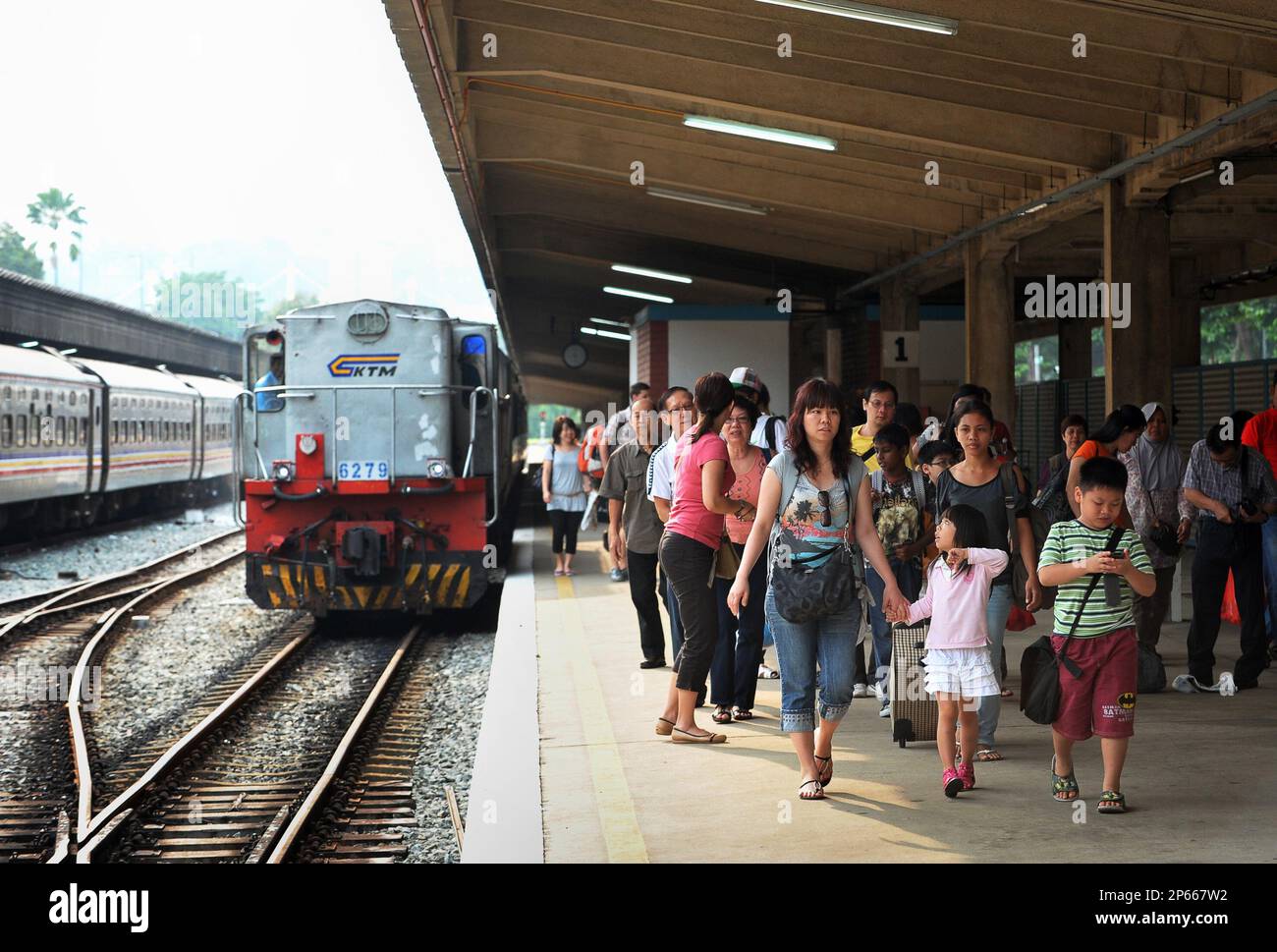 Passengers disembark from a Keretapi Tanah Melayu (KTM) train arriving ...