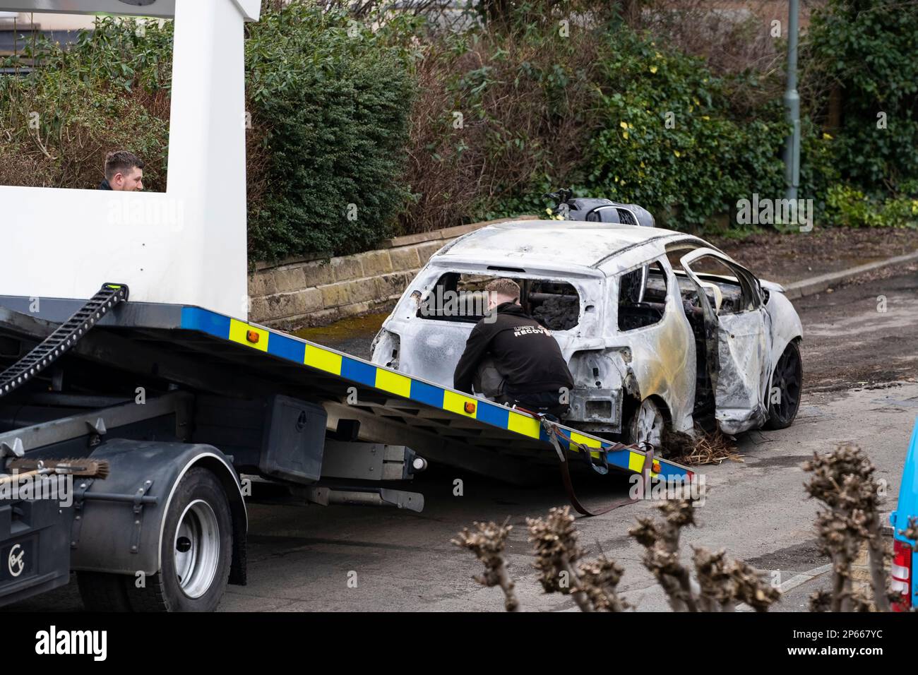Recovery vehicle removing a torched car on a slide and tilt recovery ...