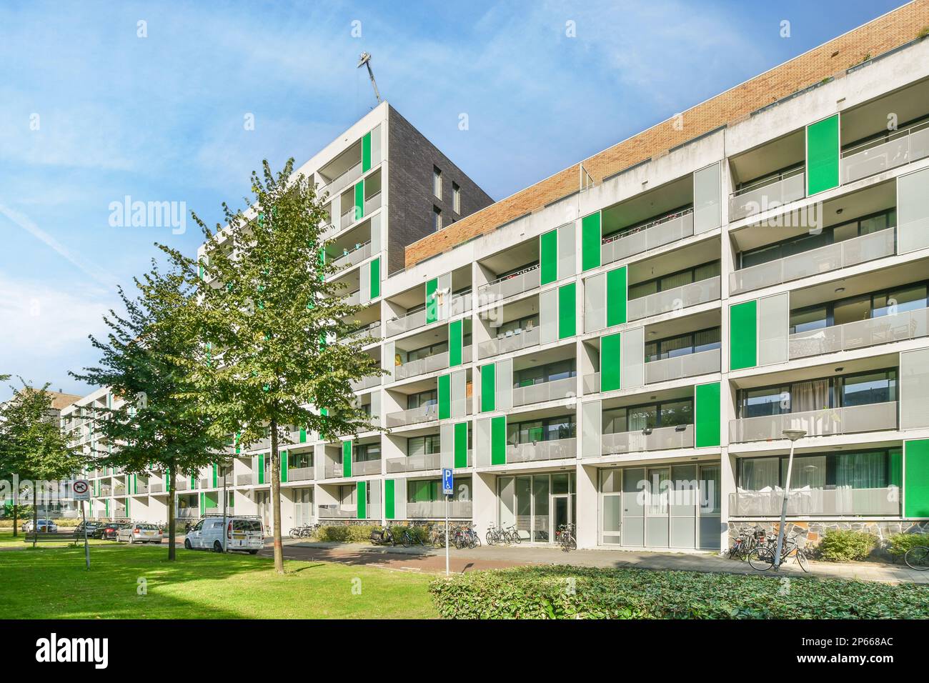 an apartment building with green shutters on the windows and trees in ...