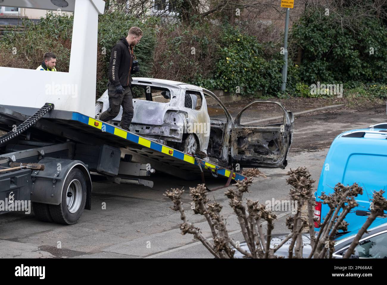 Recovery vehicle removing a torched car on a slide and tilt recovery ...