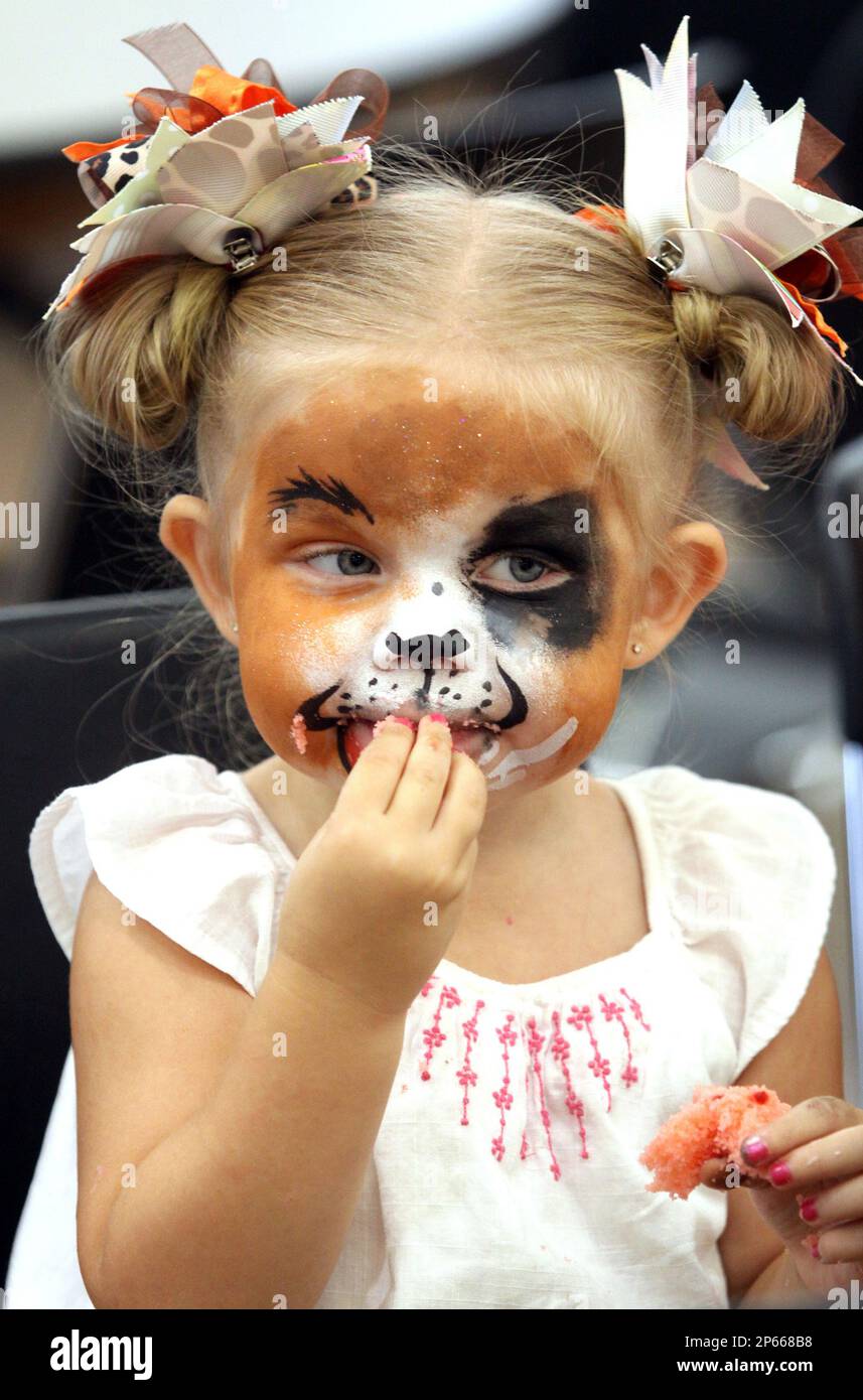 Piper Pyle, 2, who had her face painted like a puppy, eats her cupcake ...