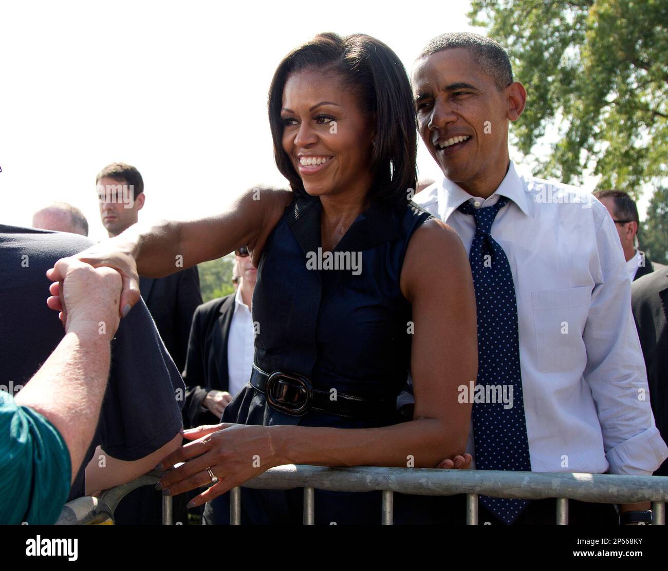 President Barack Obama and first lady Michelle Obama shake hands at a ...