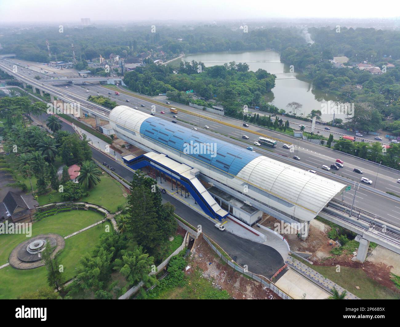 aerial view of an LRT station under construction, above the expressway ...