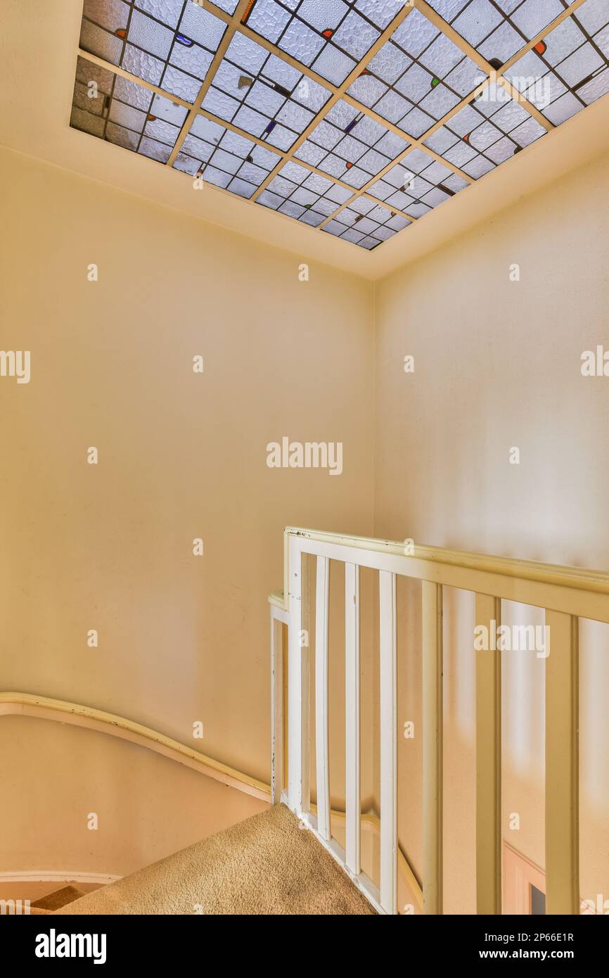 the inside of a room with a skylight above it and stairs leading up to ...