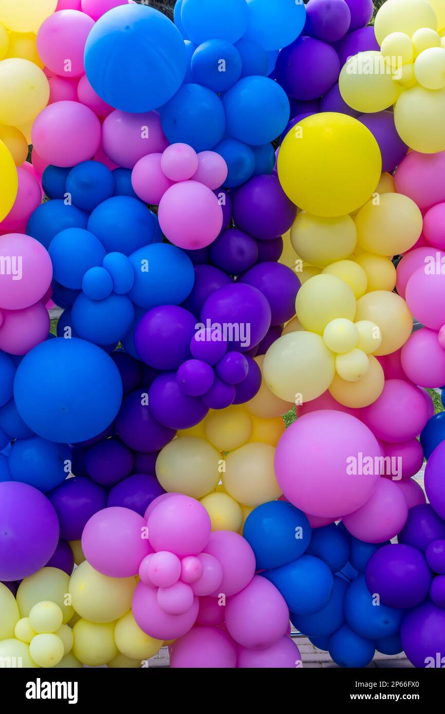 Bright abstract background of jumble of rainbow colored balloons ...