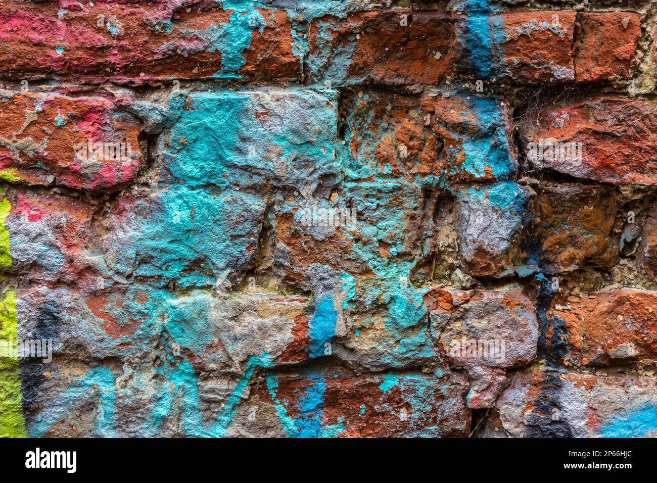 Brick wall with multi-colored paint close-up. Background brick creative ...