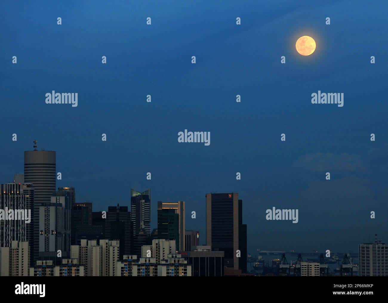 Photograph of the full moon as it rises over Singapore on 19 March 2011 ...
