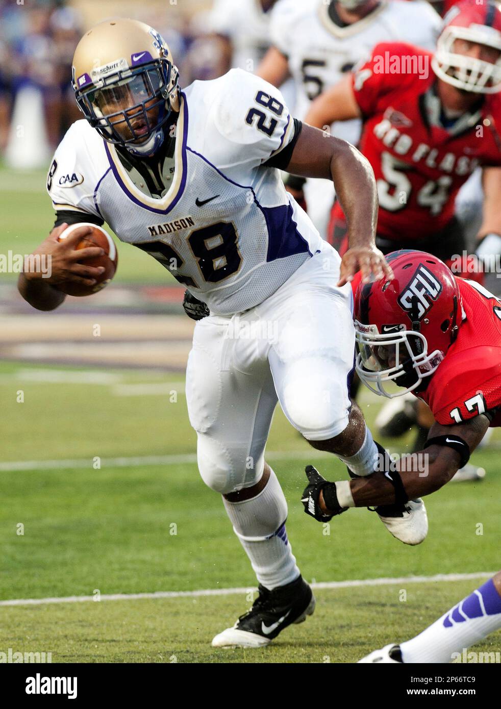 James Madison's Jordan Anderson rushes as St. Francis' Dwight Andrews ...