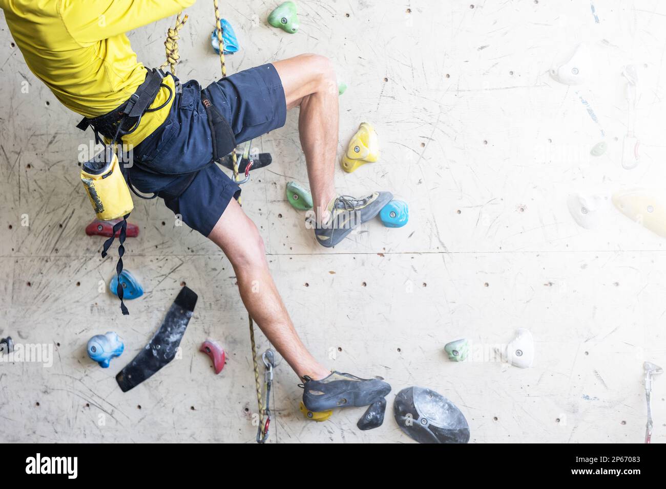 Close up view of young man or climber feet in climbing shoes on ...