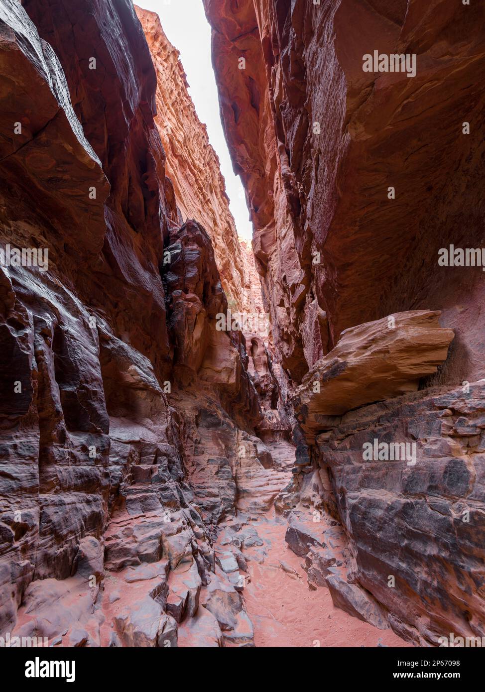 A narrow rocky red canyon in Wadi Rum desert in Jordan, Middle East ...