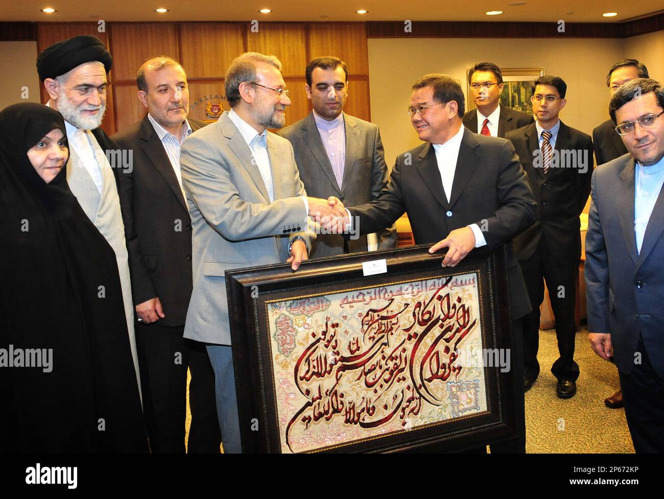 Iranian Speaker Ali Larijani (fourth from left) presenting a gift to ...