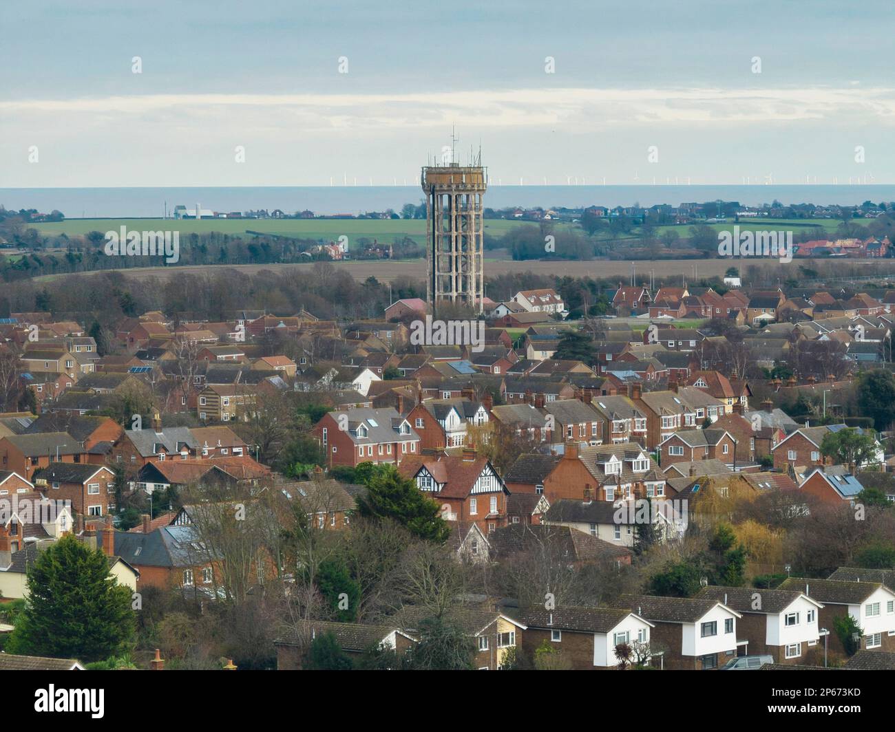 An old water tower rises above a Suffolk village, England Stock Photo ...