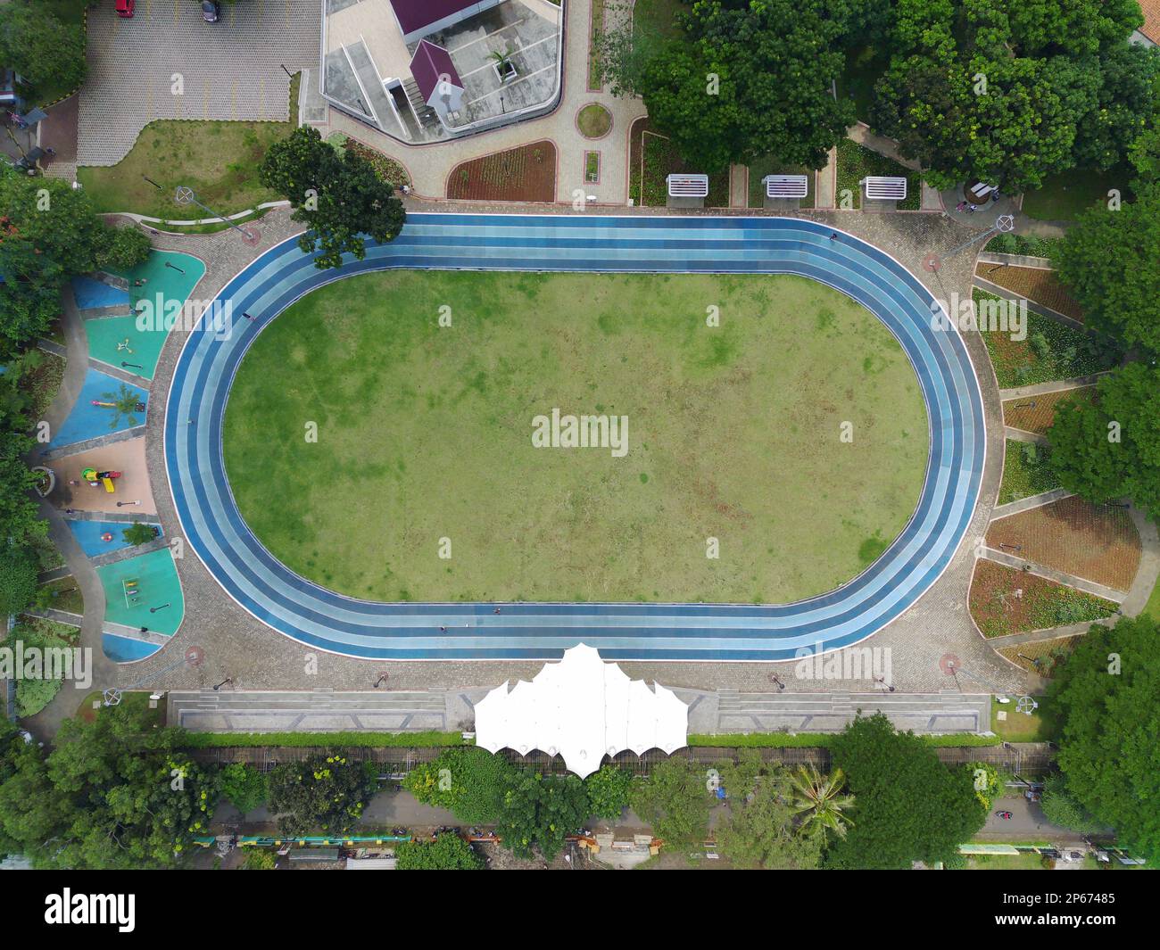 aerial view of a green open space called alun-alun Cirimekar for sports ...