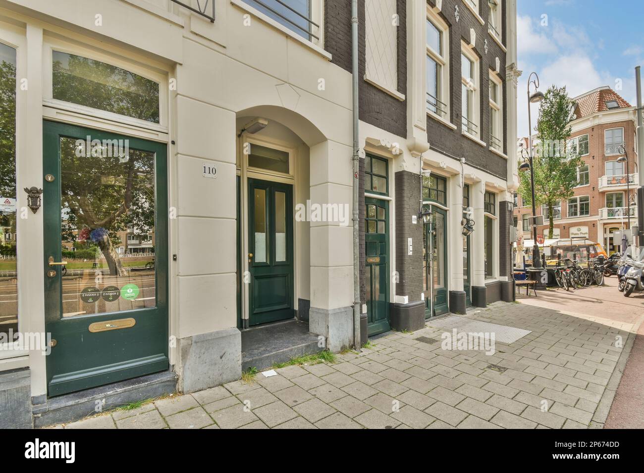 a city street with buildings and bicycles parked on the side of the ...