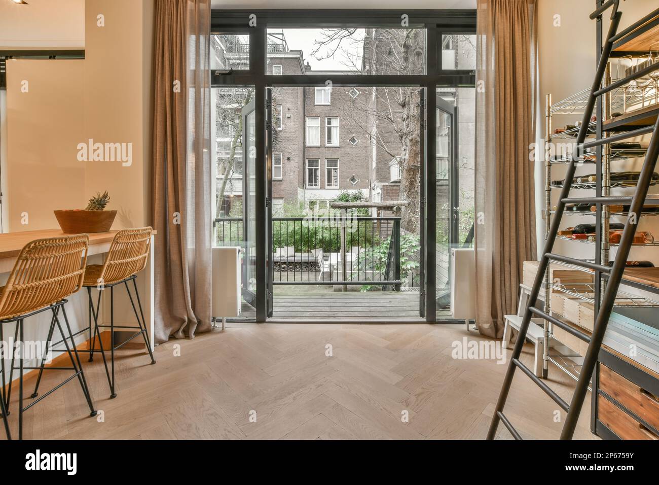 a living room with wood flooring and sliding glass doors that open onto ...