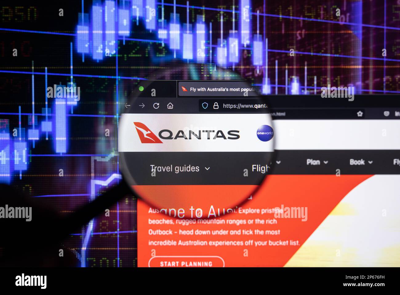 Qantas airline company logo on a website with blurry stock market developments in the background ...