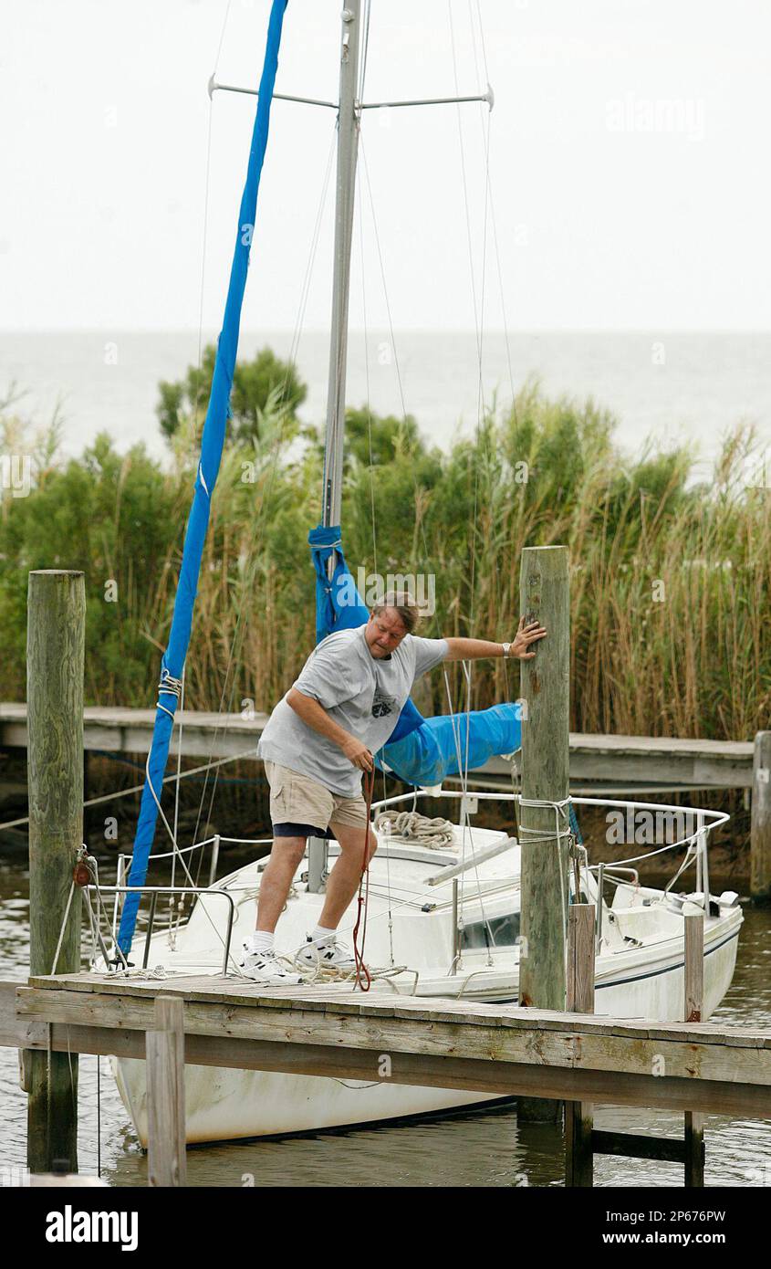 Chris Kern secures his sailboat at Buccaneer Yacht Club Monday, Aug. 27 ...