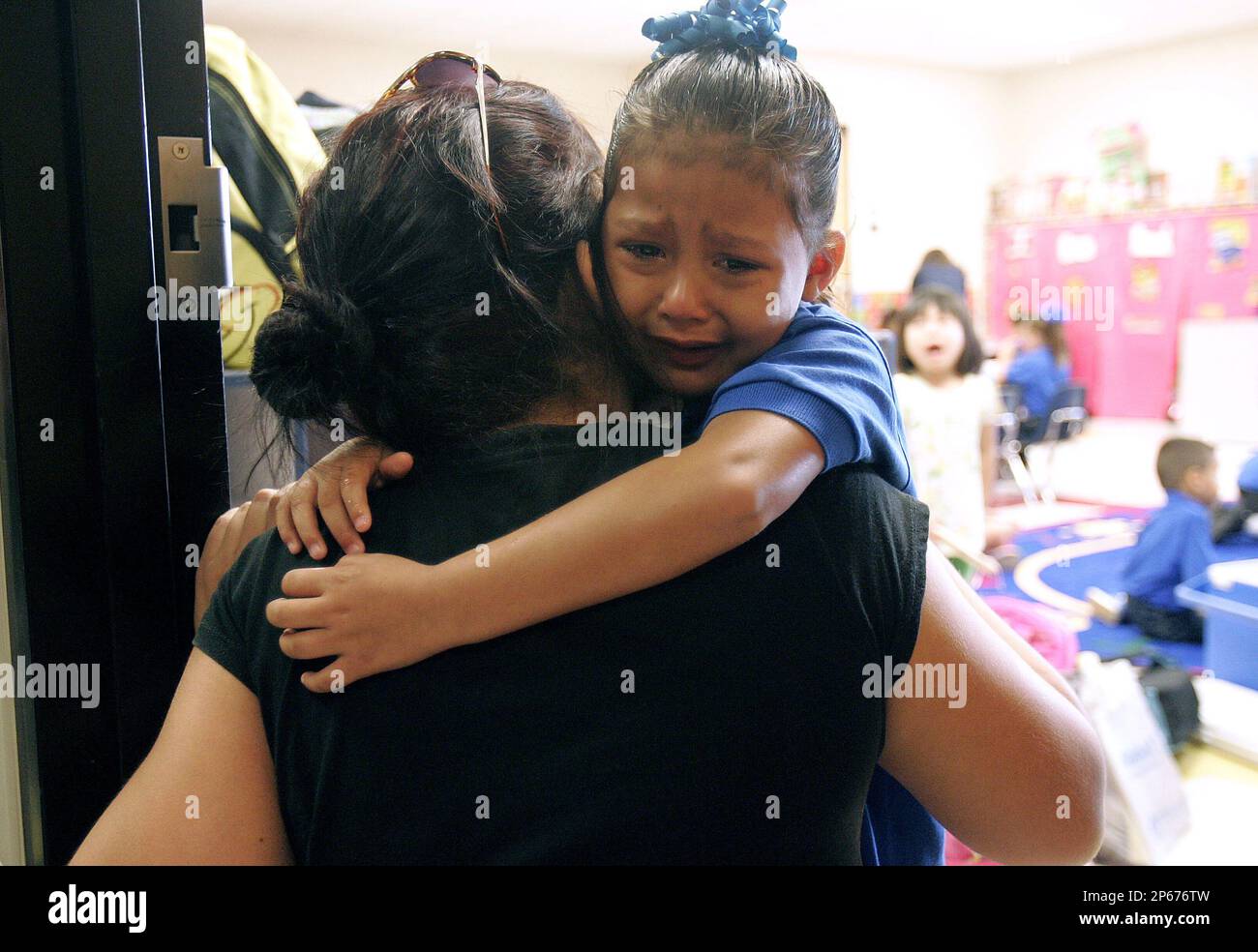 Erica Gonzalez cries and hugs her mother Rebekah Rodriguez as she ...