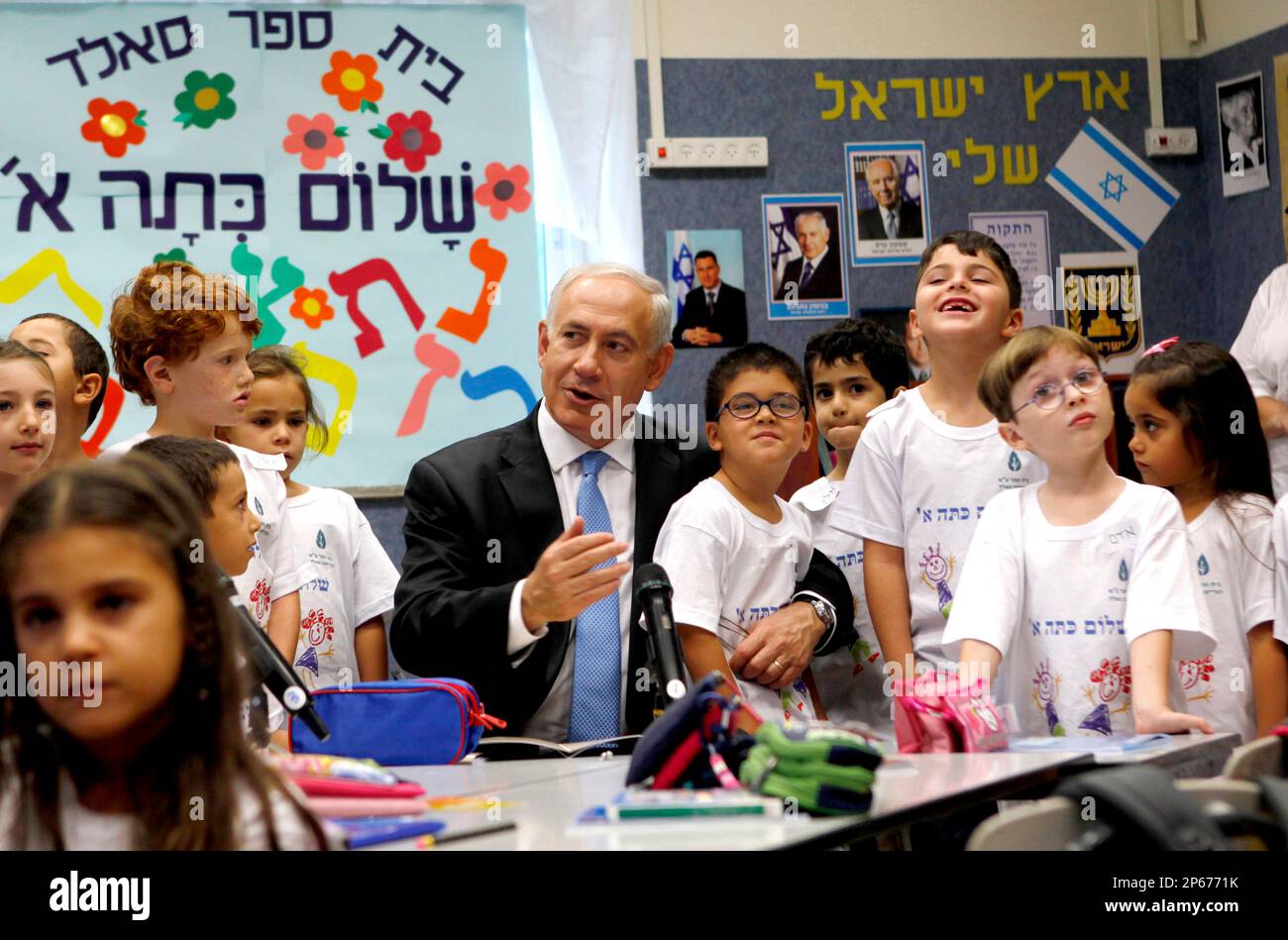 Israeli Prime Minister Benjamin Netanyahu sits with first grade pupils ...