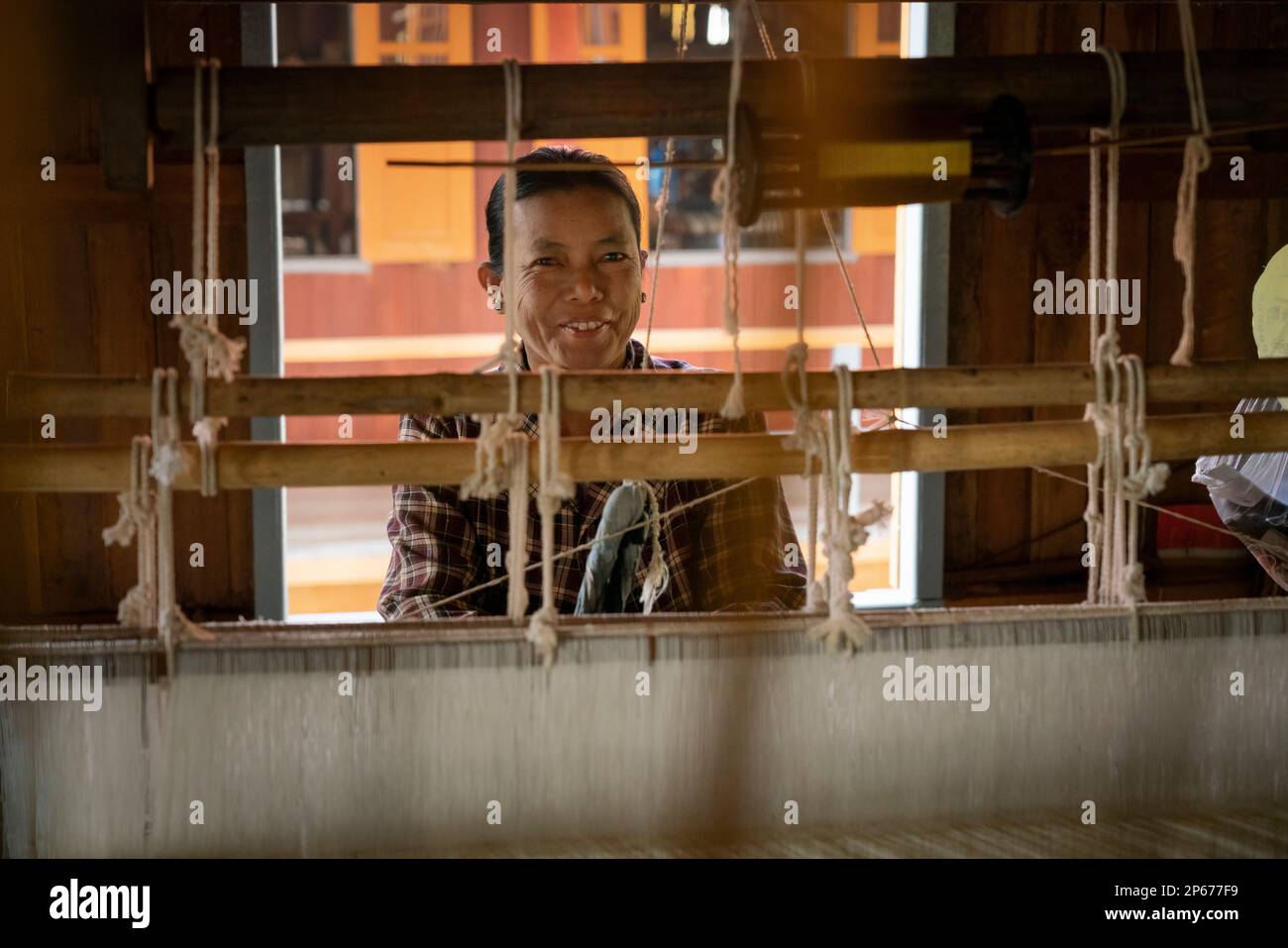 Burmese woman working on loom at workshop, Lake Inle, Shan State ...
