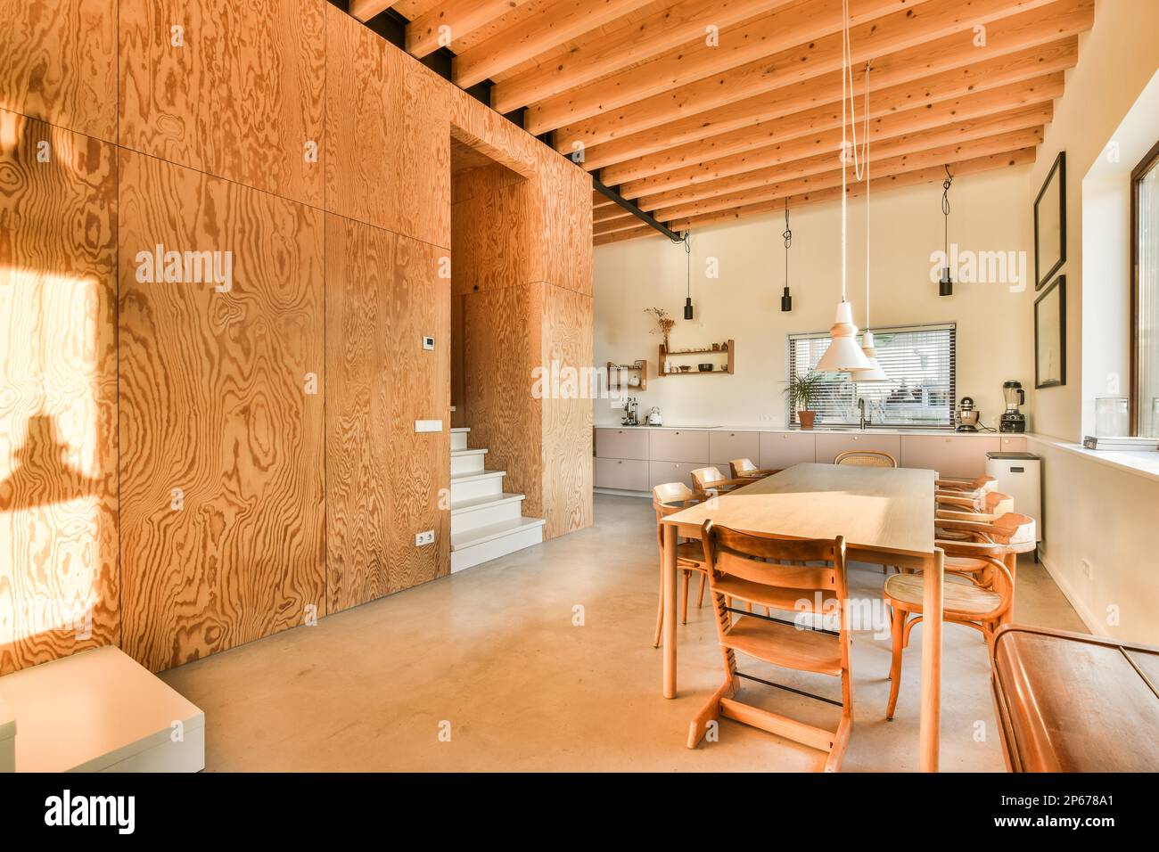 a kitchen and dining area in a house with wood paneling on the walls ...