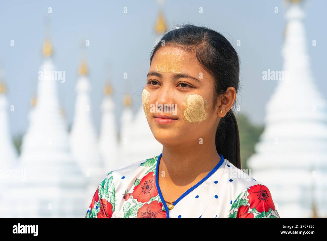 Young Burmese woman at white stupas of Sanda Muni Pagoda (Sanda Mu Ni ...