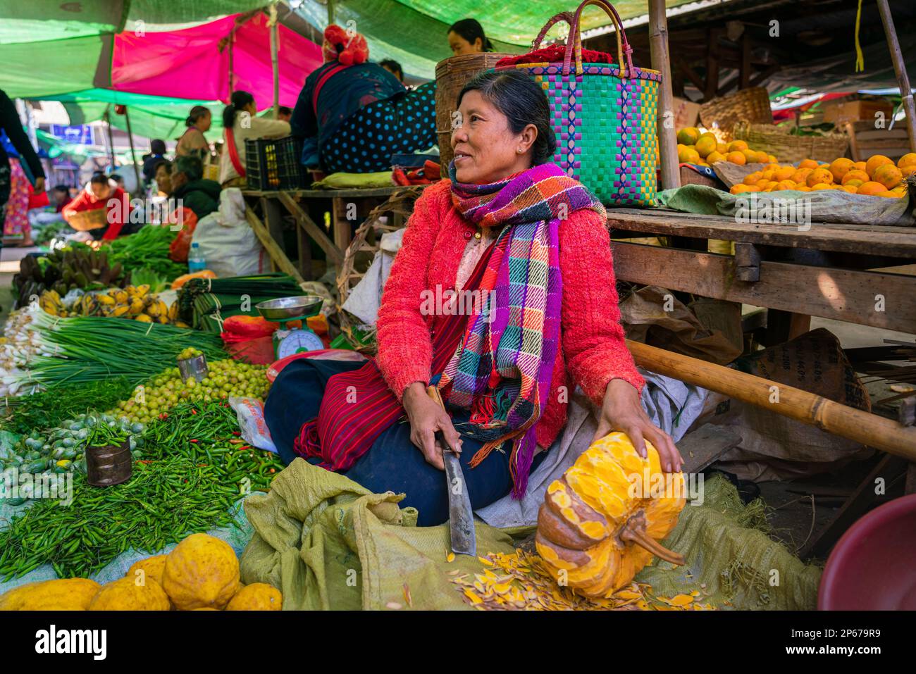 Burmese woman selling fruits and vegetables at local market, Lake Inle ...