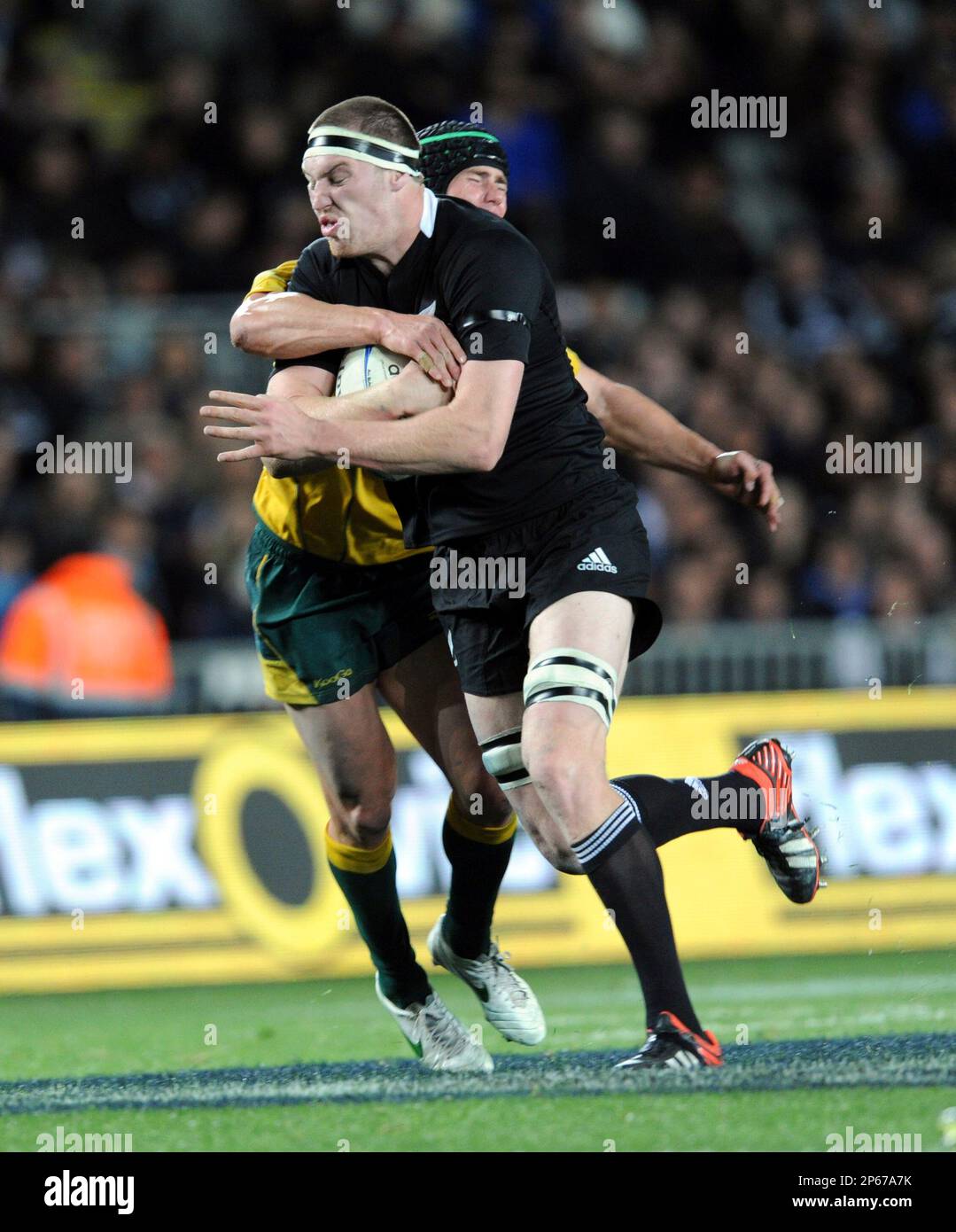 New Zealand's Brodie Retallick runs through the tackle of Australia's ...