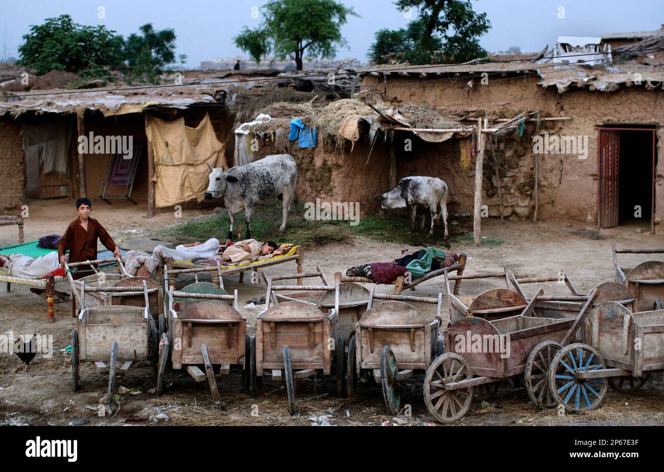 In this Wednesday, Aug. 8, 2012 photo, an Afghan refugee youth, left ...