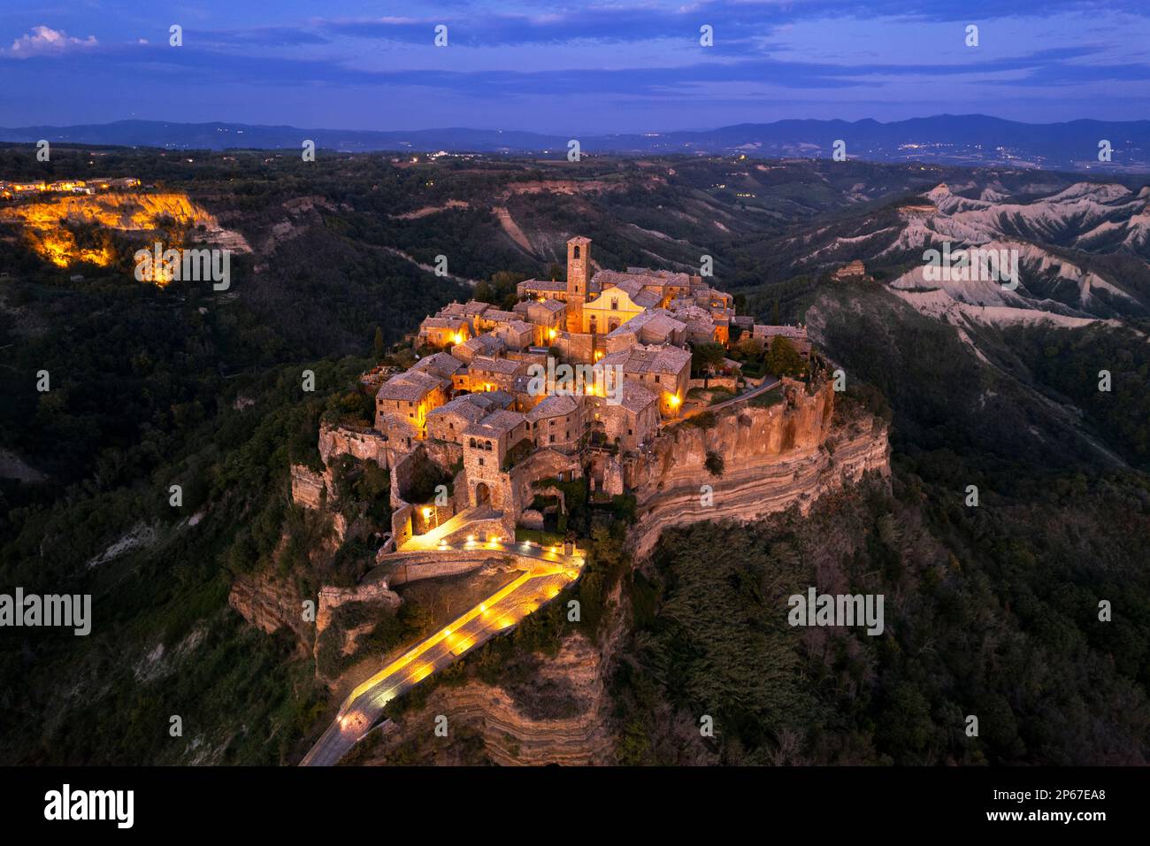 Aerial view of the medieval village of Civita di Bagnoregio lit at dusk ...