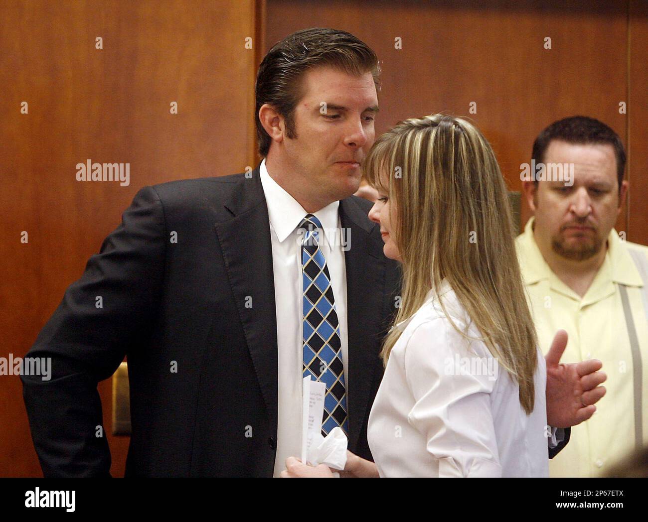 Shawnee County District Attorney Chad Taylor, left, pats Haley Sisco on ...