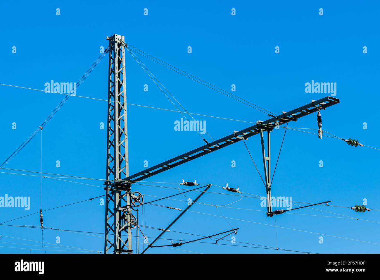 Part of the contact line on the railway. Metal pole and wires against ...