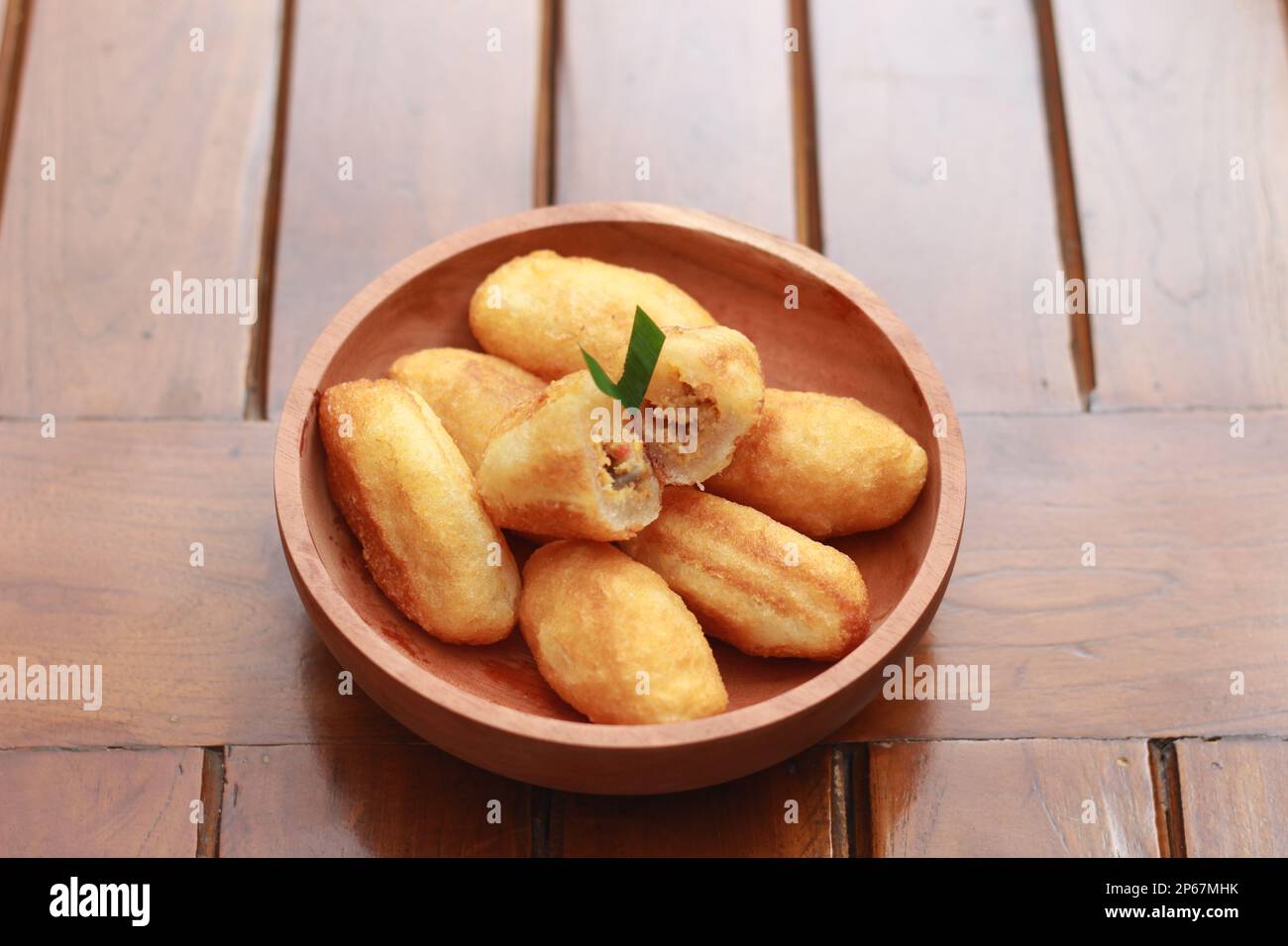 Comro or combro, a traditional Javanese snack made of deep fried grated cassava filled with a ...
