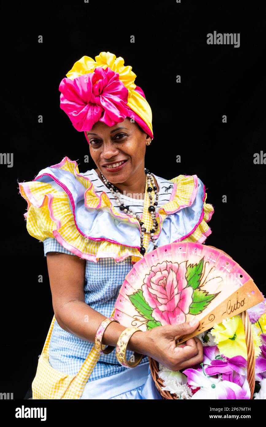 Colourful flower girl with headdress, fan and basket, Havana, Cuba ...