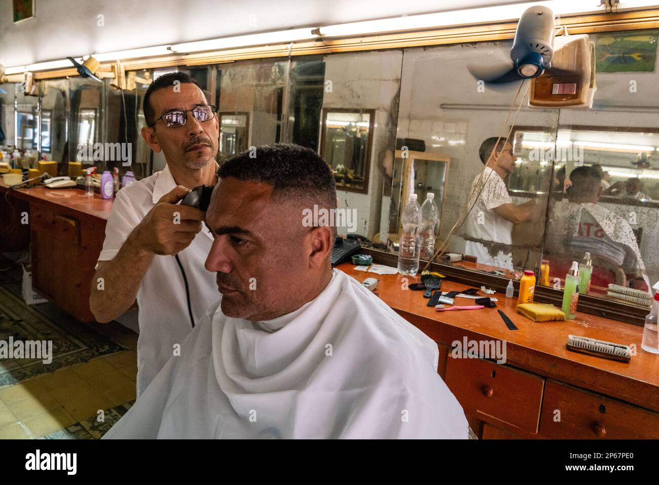Cuban having his haircut, Old Havana, Cuba, West Indies, Caribbean ...