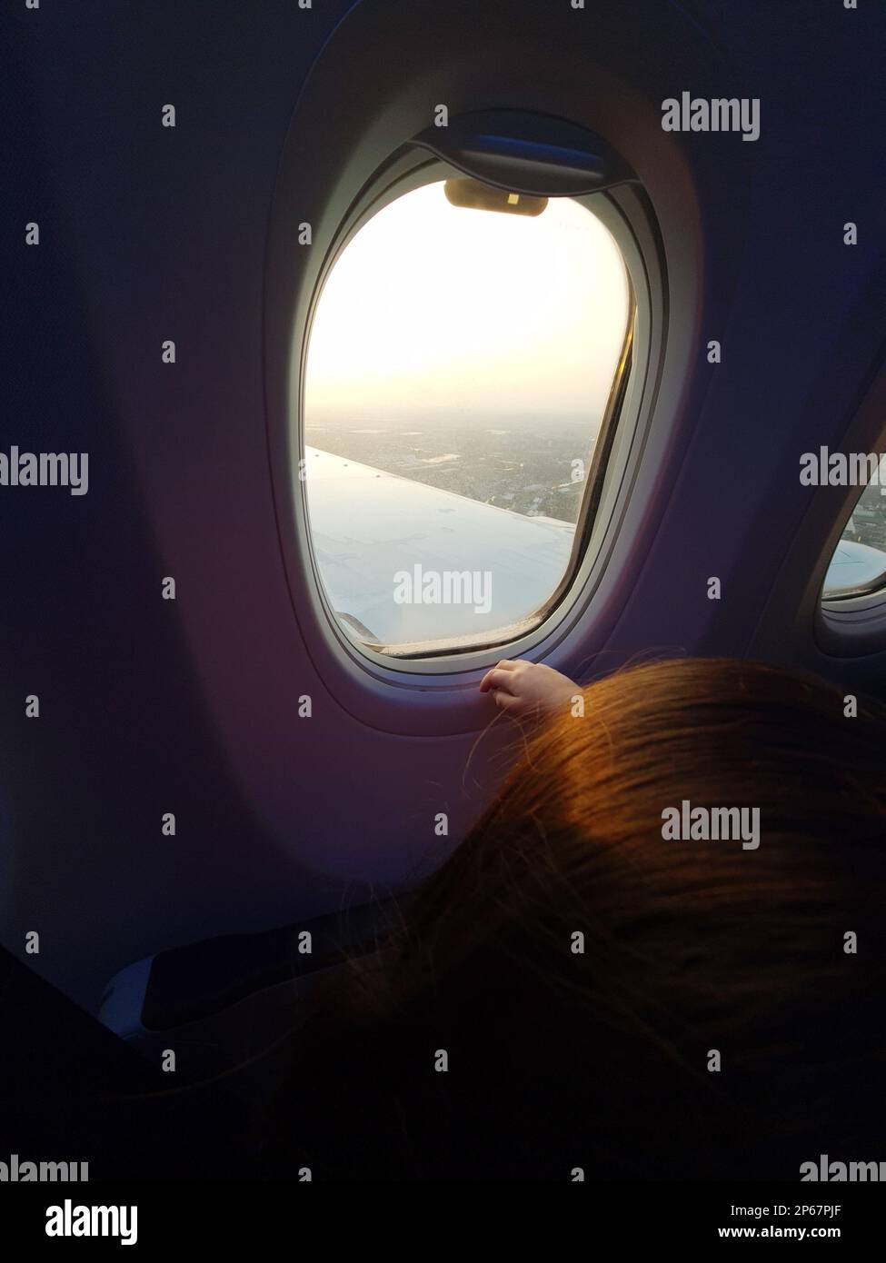 Baby passenger fly in airplane next to window Stock Photo - Alamy